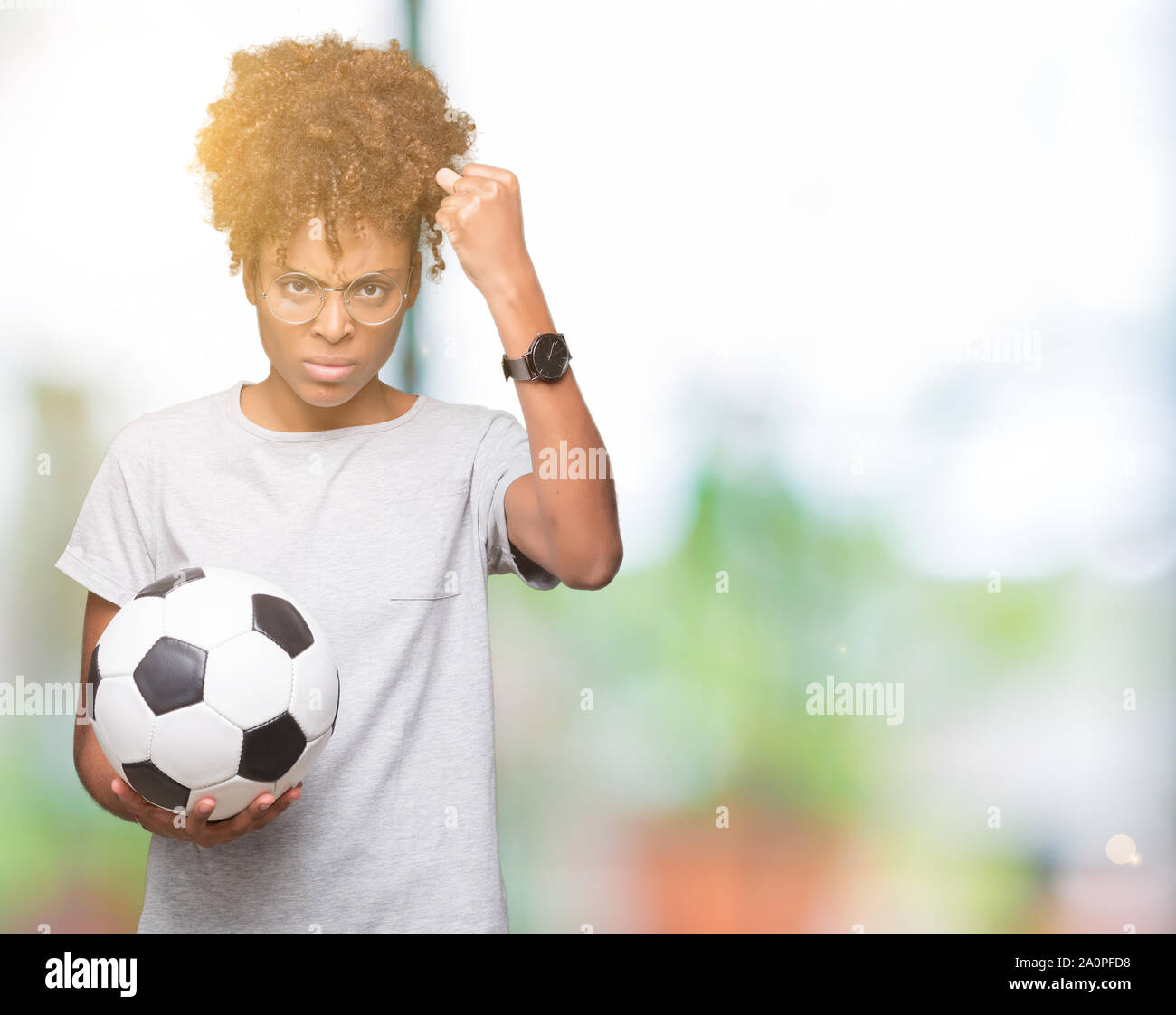 Young african american woman holding soccer football ball over isolated ...
