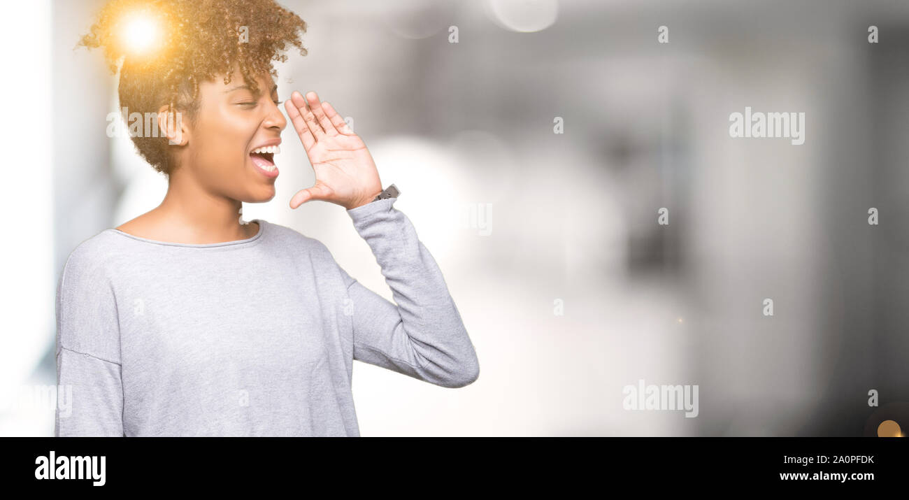 Beautiful young african american woman over isolated background ...