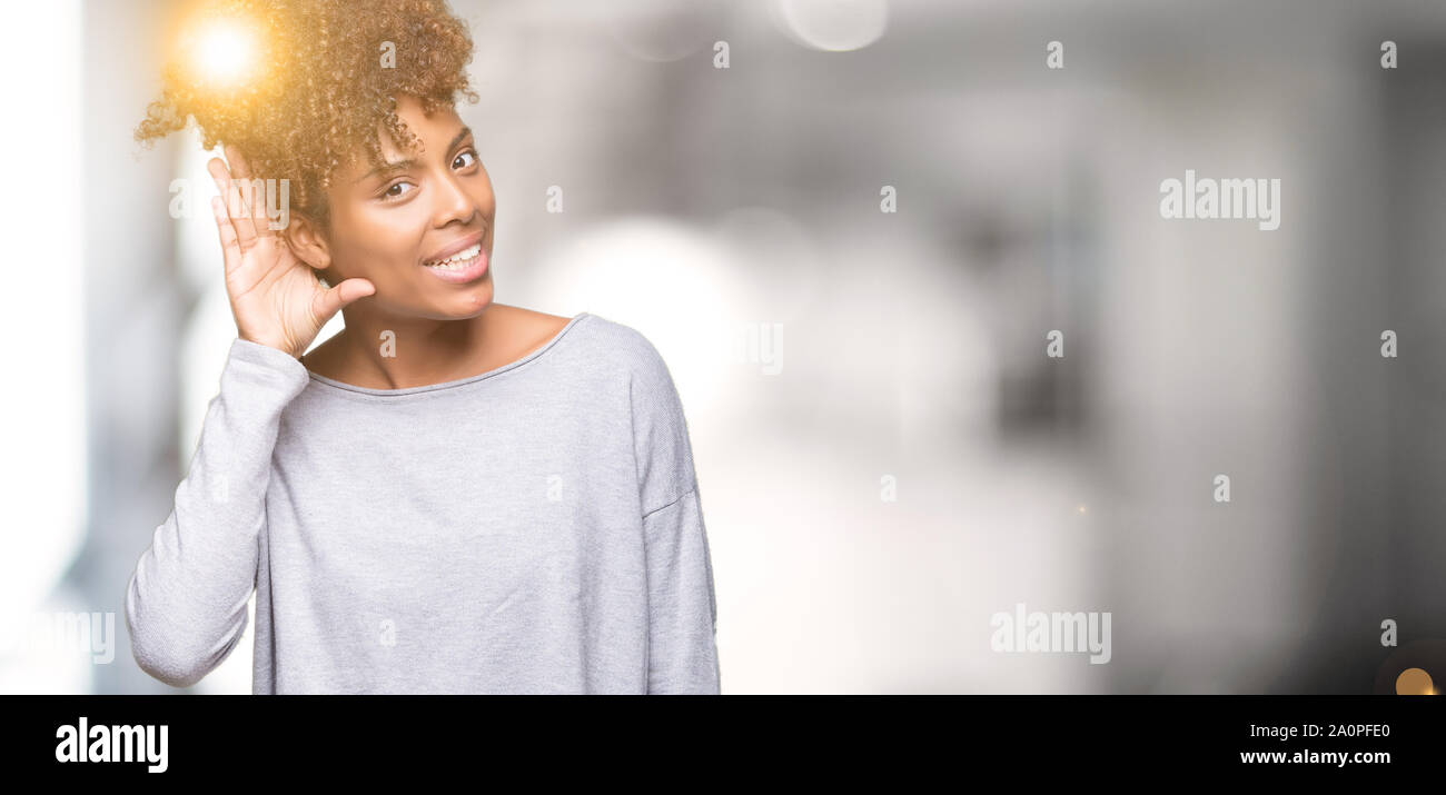 Beautiful young african american woman over isolated background smiling ...
