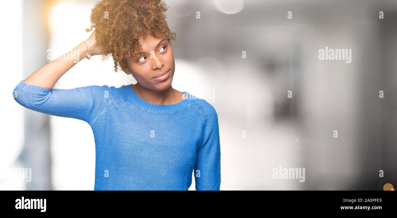 Beautiful young african american woman over isolated background confuse ...