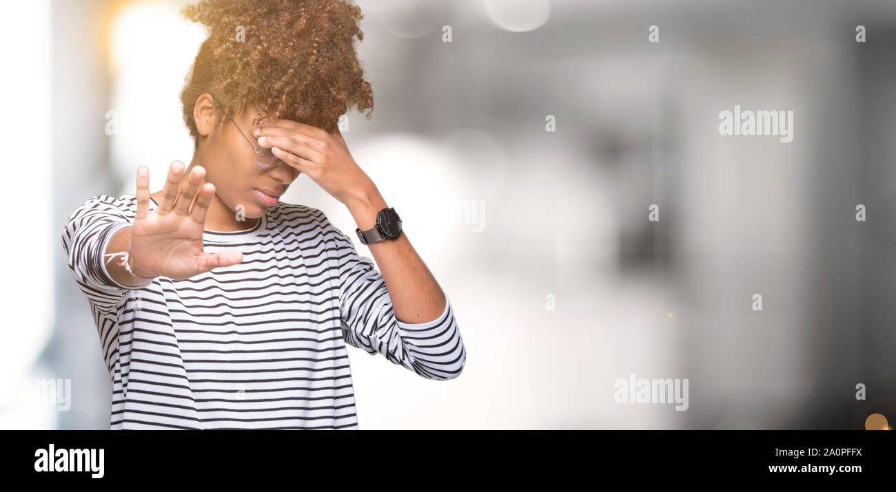 Beautiful young african american woman wearing glasses over isolated ...
