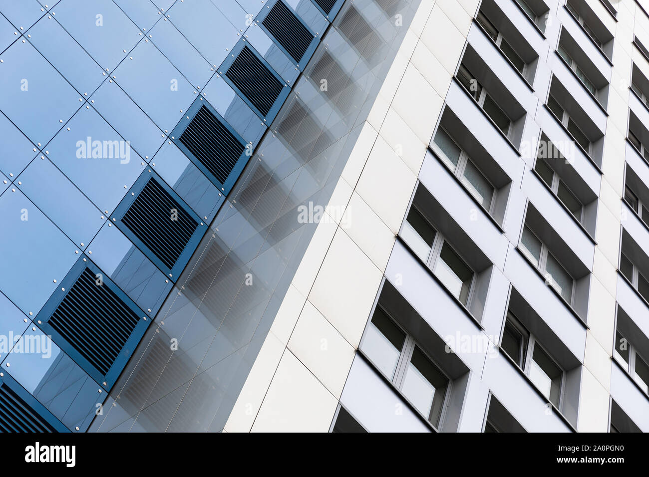 Ground view of tall modern building facade, blue and white smooth ...