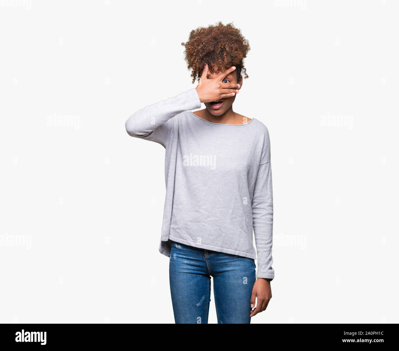 Beautiful young african american woman over isolated background peeking ...