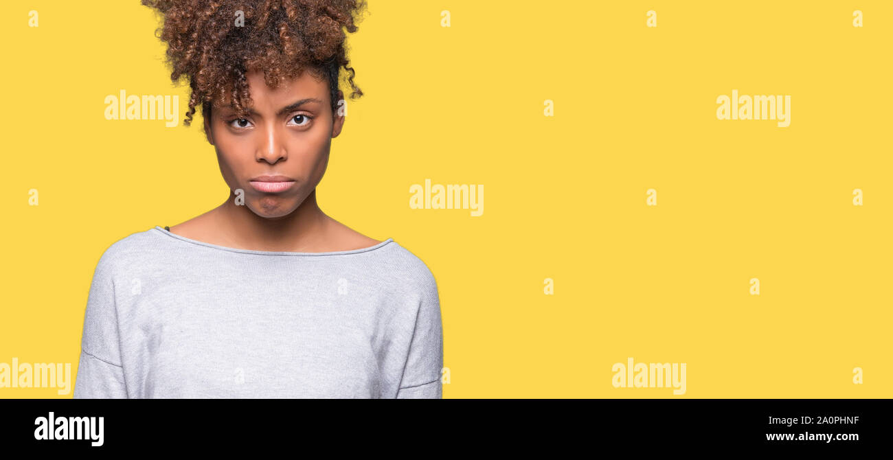 Beautiful young african american woman over isolated background ...