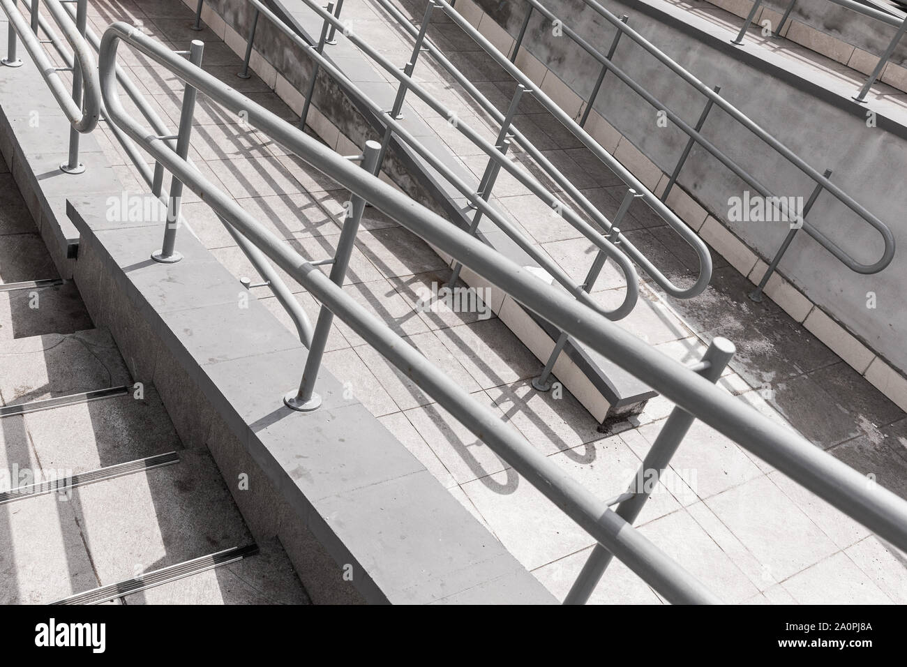 Gray stainless handrails for handicapped people on concrete stairs ...