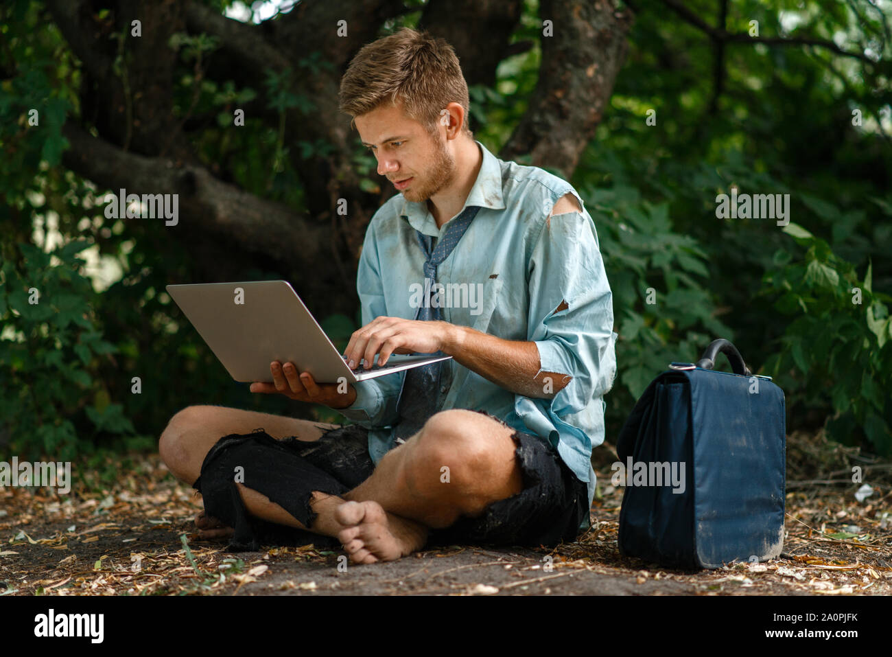 Alone office worker with laptop on desert island Stock Photo - Alamy