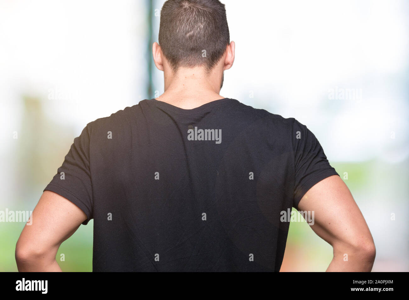 Young handsome man over isolated background standing backwards looking ...