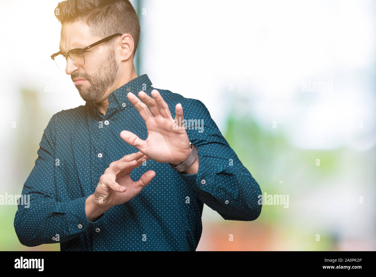 Young handsome business man wearing glasses over isolated background ...