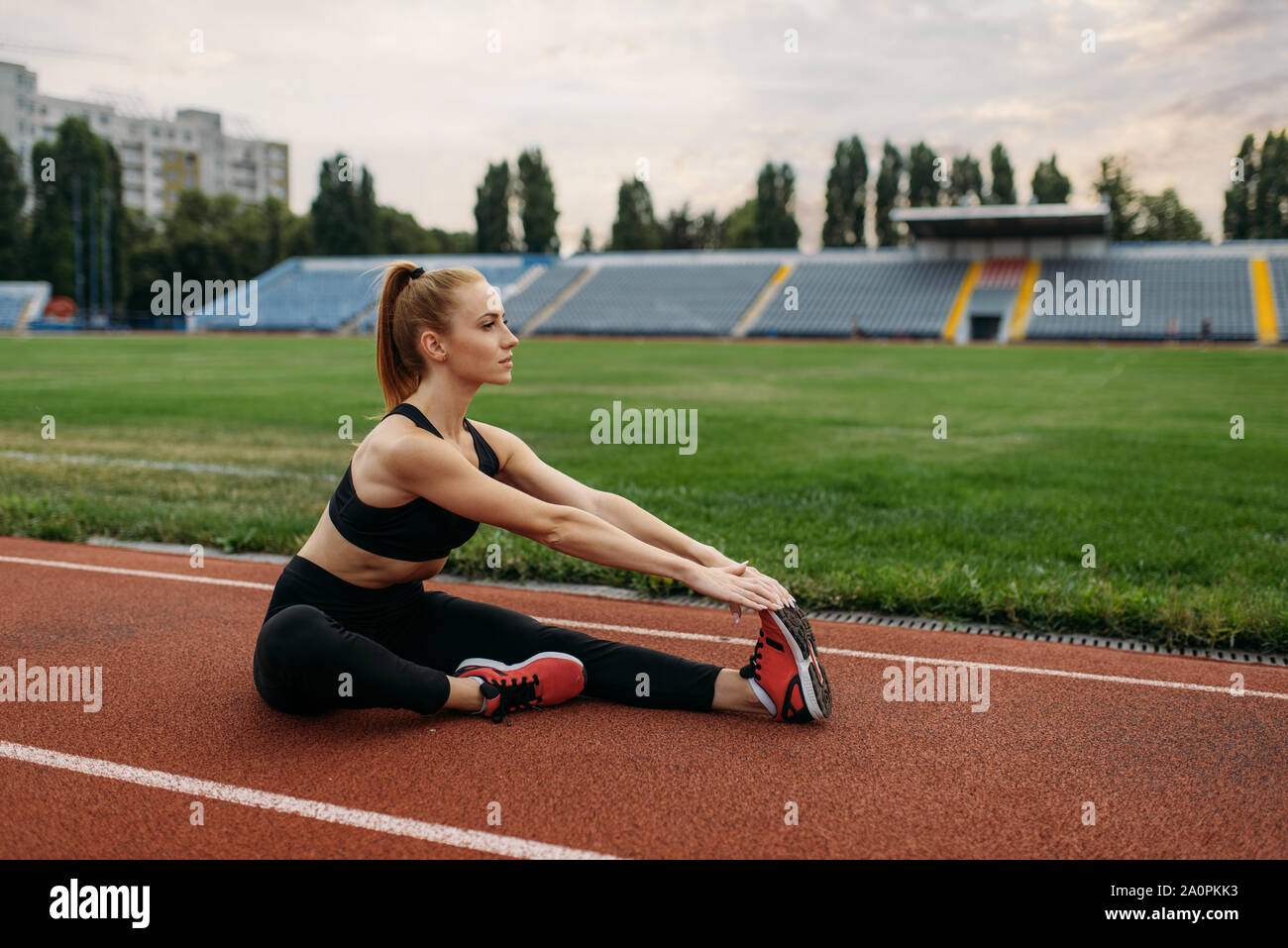 Female runner in sportswear, training on stadium Stock Photo - Alamy