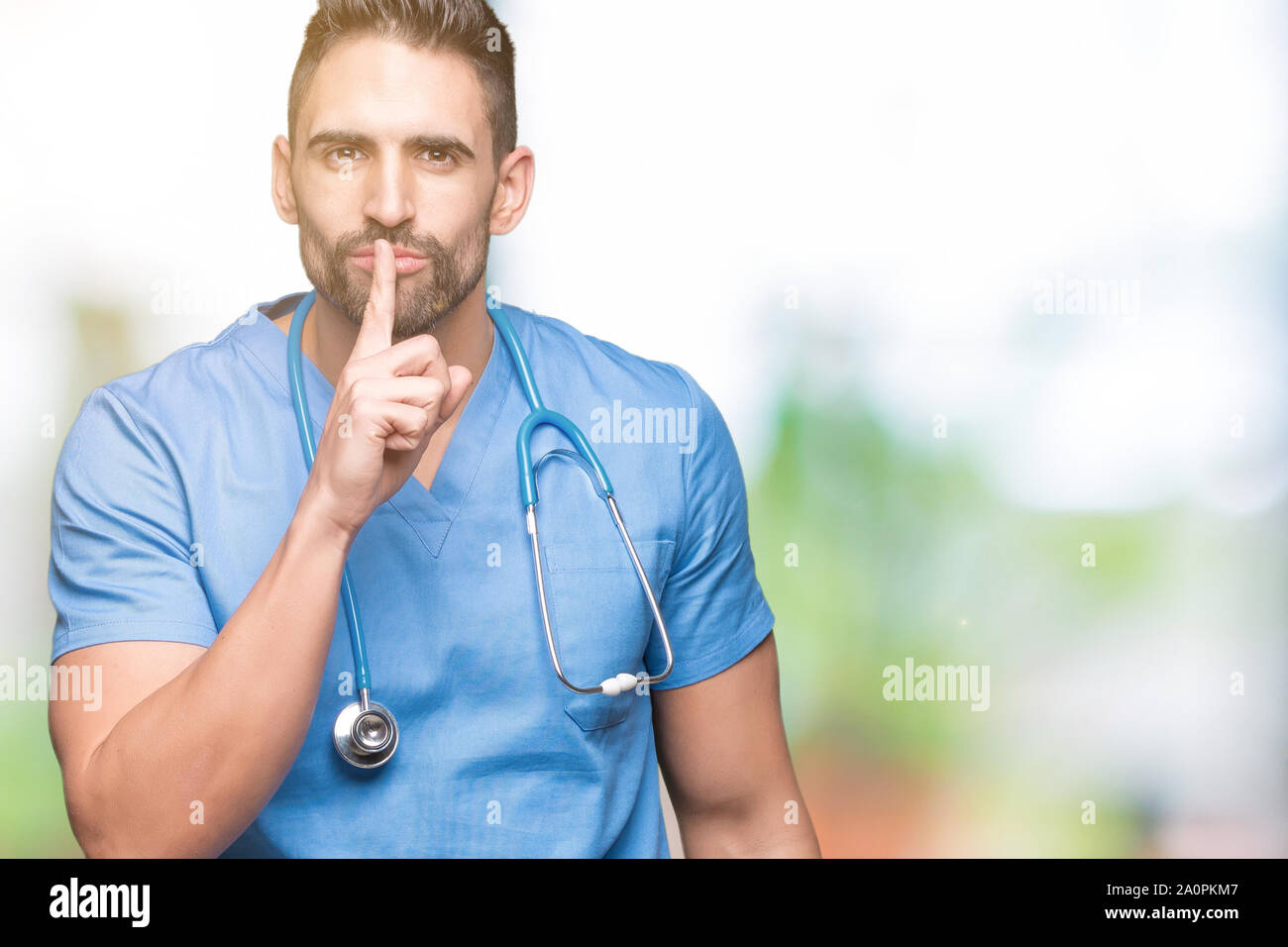 Handsome young doctor surgeon man over isolated background asking to be ...