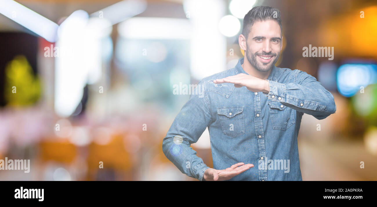 Young handsome man over isolated background gesturing with hands ...