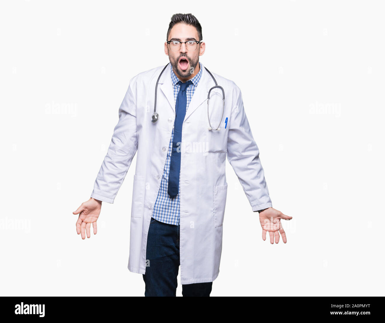 Handsome young doctor man over isolated background In shock face ...
