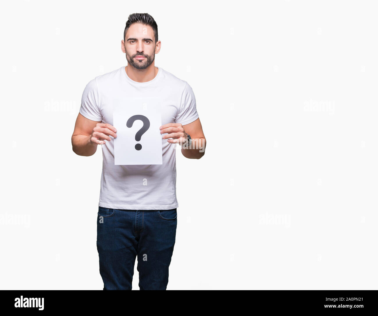 Handsome young man holding paper with question mark over isolated ...
