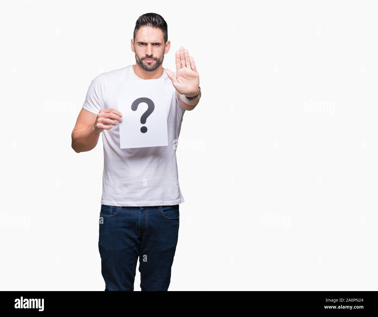 Handsome young man holding paper with question mark over isolated ...