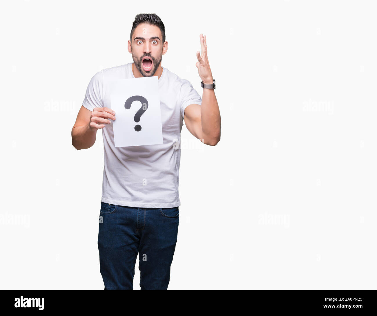 Handsome young man holding paper with question mark over isolated ...