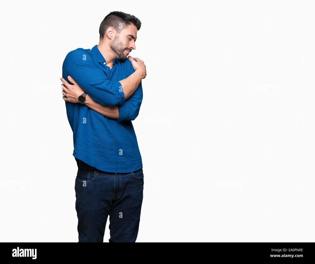 Young handsome man over isolated background Hugging oneself happy and ...