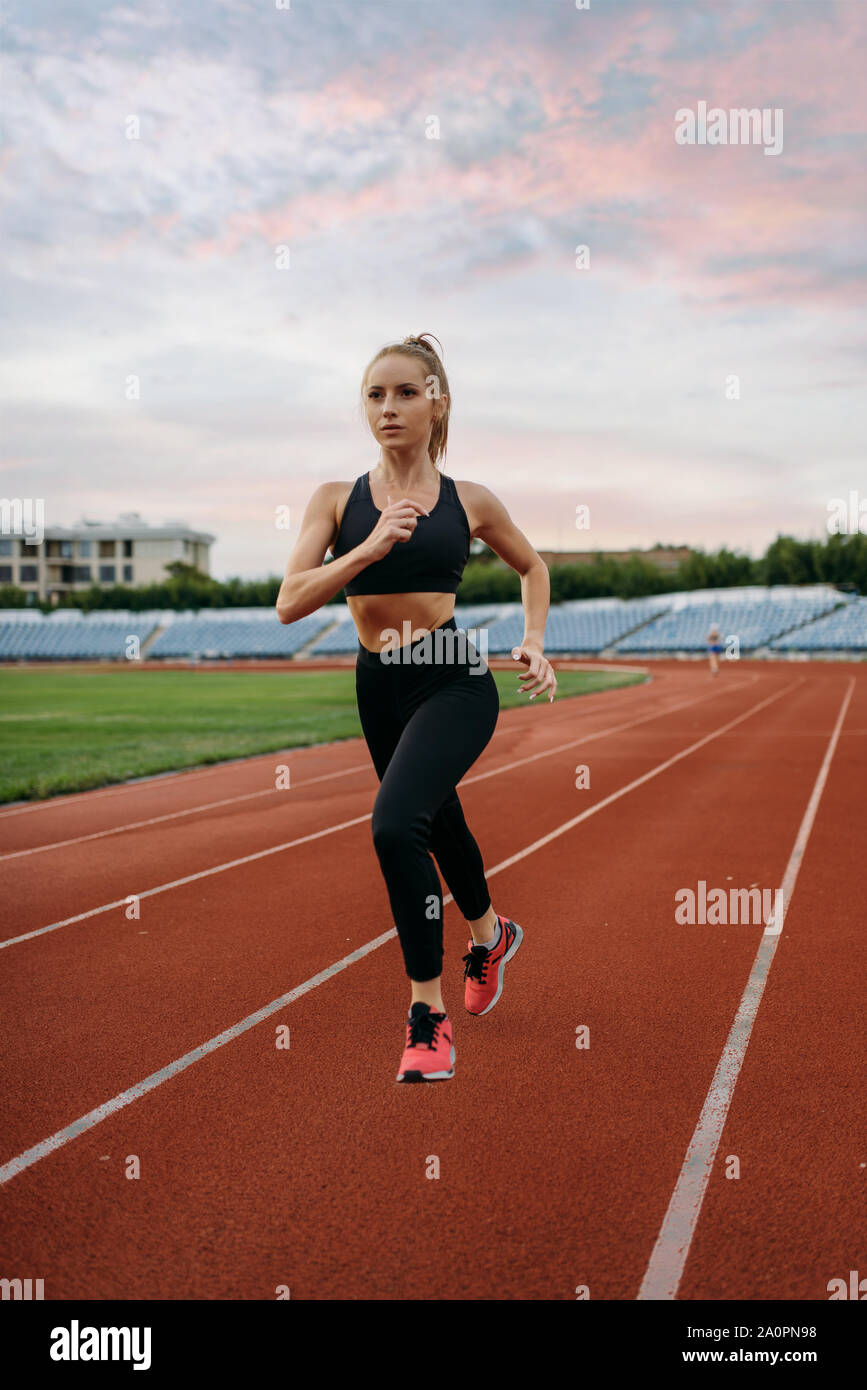 Female runner jogging, training on stadium Stock Photo - Alamy