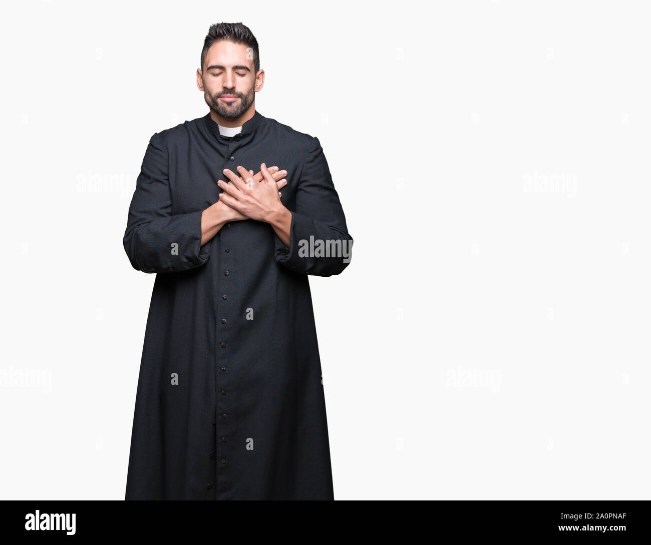 Young Christian priest over isolated background smiling with hands on ...