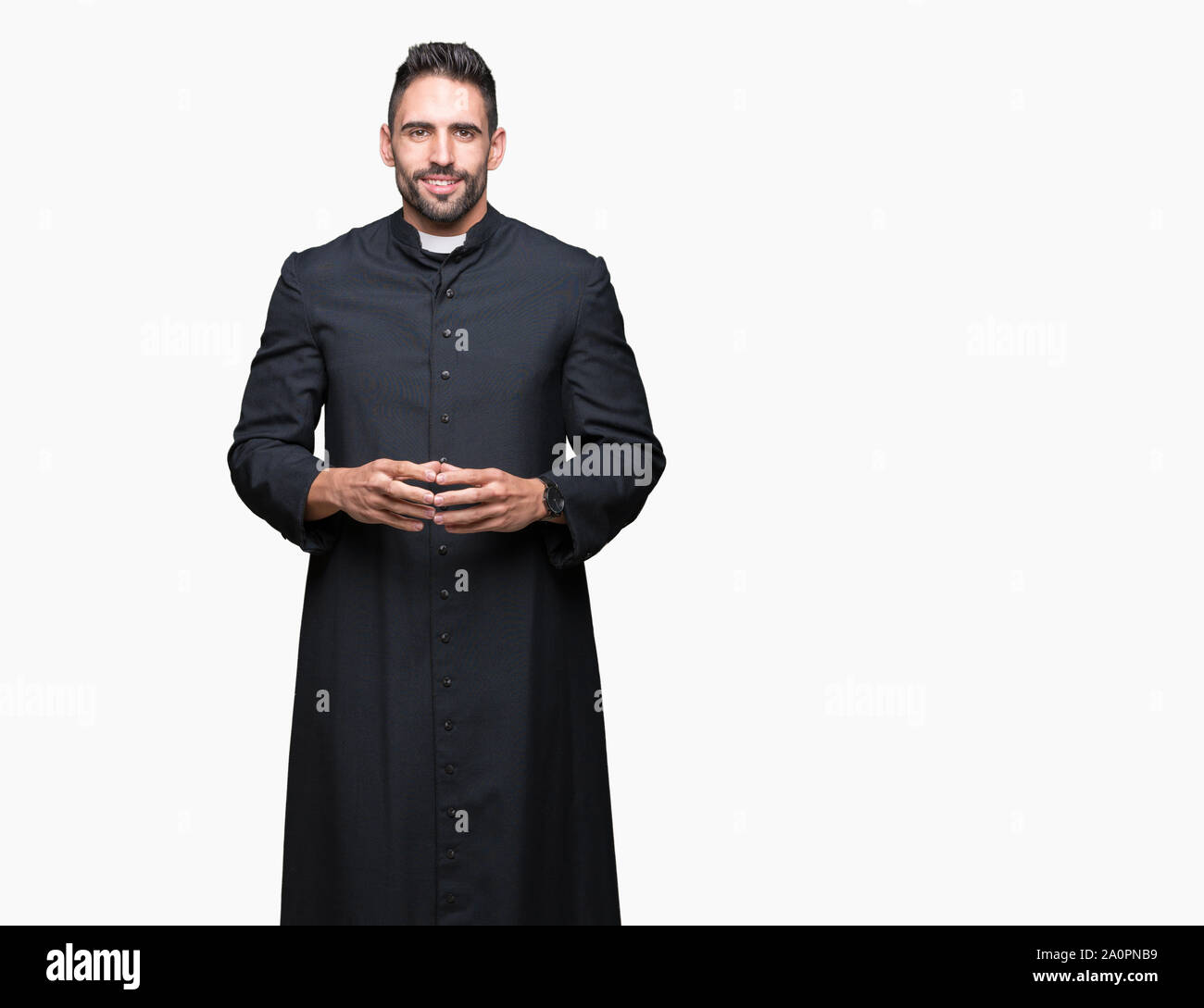 Young Christian priest over isolated background Hands together and ...