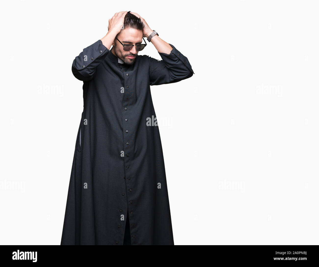 Young Christian priest wearing sunglasses over isolated background ...