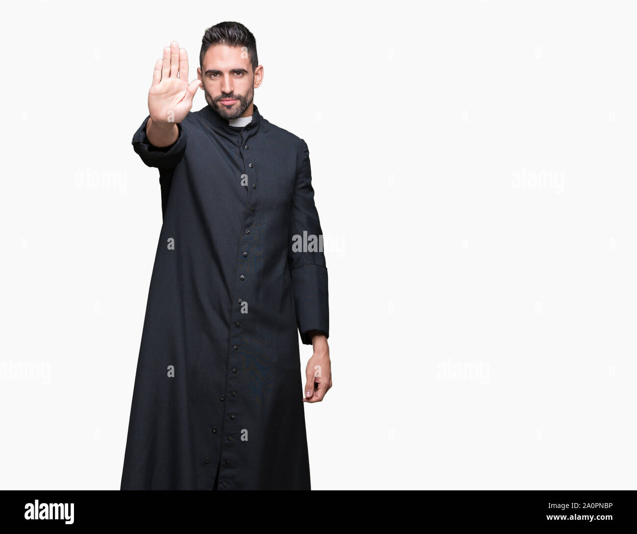 Young Christian priest over isolated background doing stop sing with ...