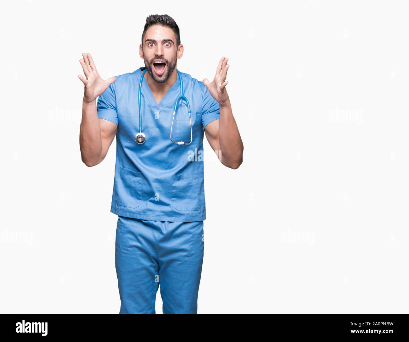 Handsome young doctor surgeon man over isolated background celebrating ...