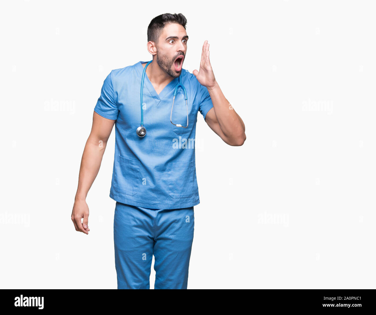 Handsome young doctor surgeon man over isolated background shouting and ...
