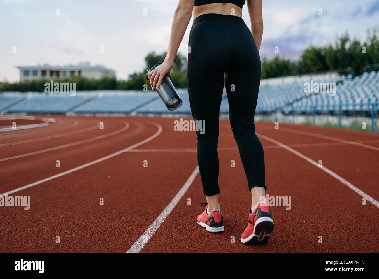 Female runner, back view, training on stadium Stock Photo - Alamy