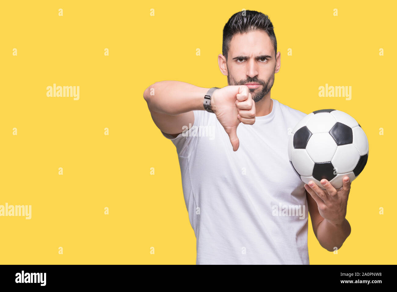 Young man holding soccer football ball over isolated background with ...