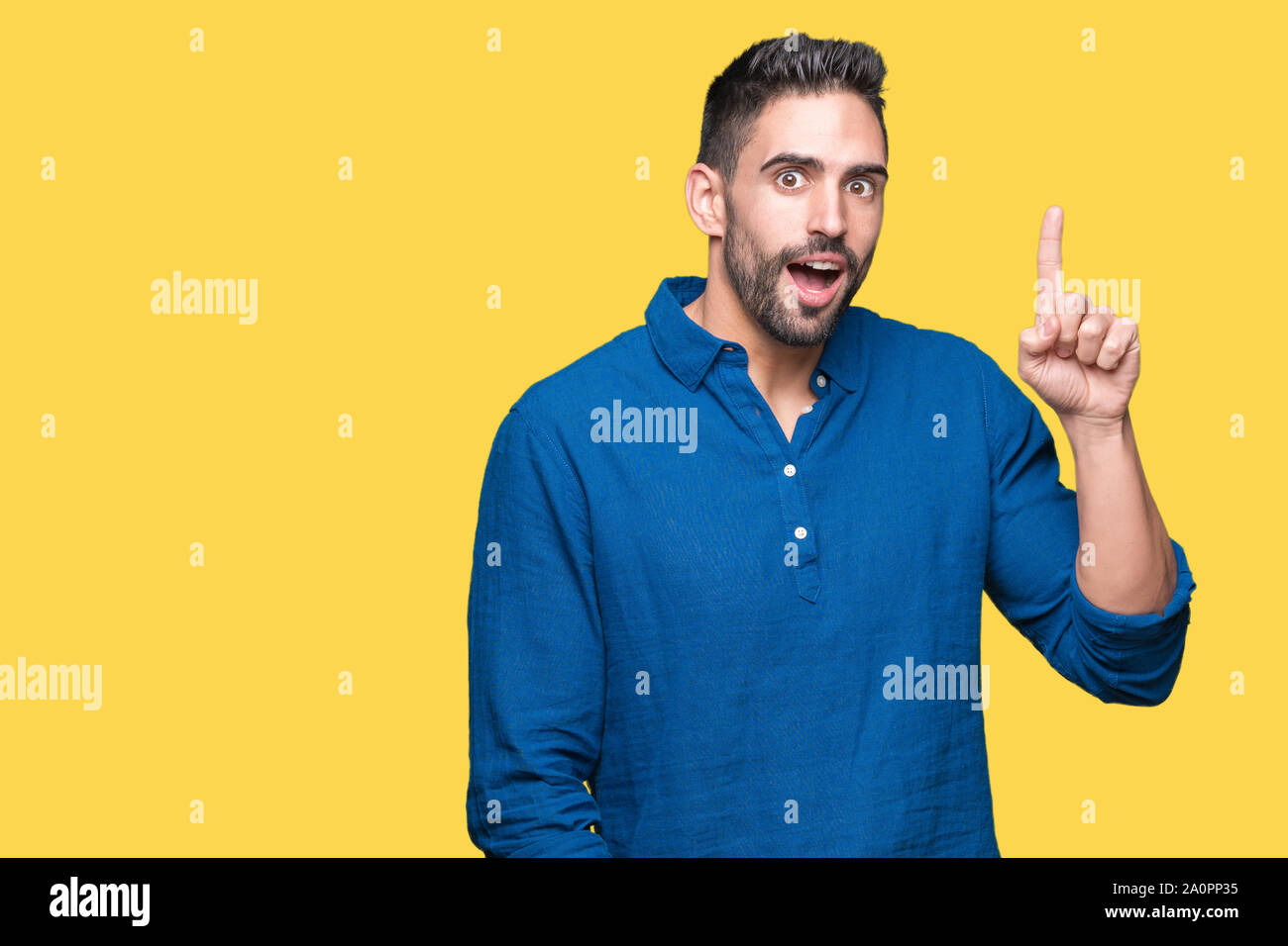 Young handsome man over isolated background pointing finger up with ...