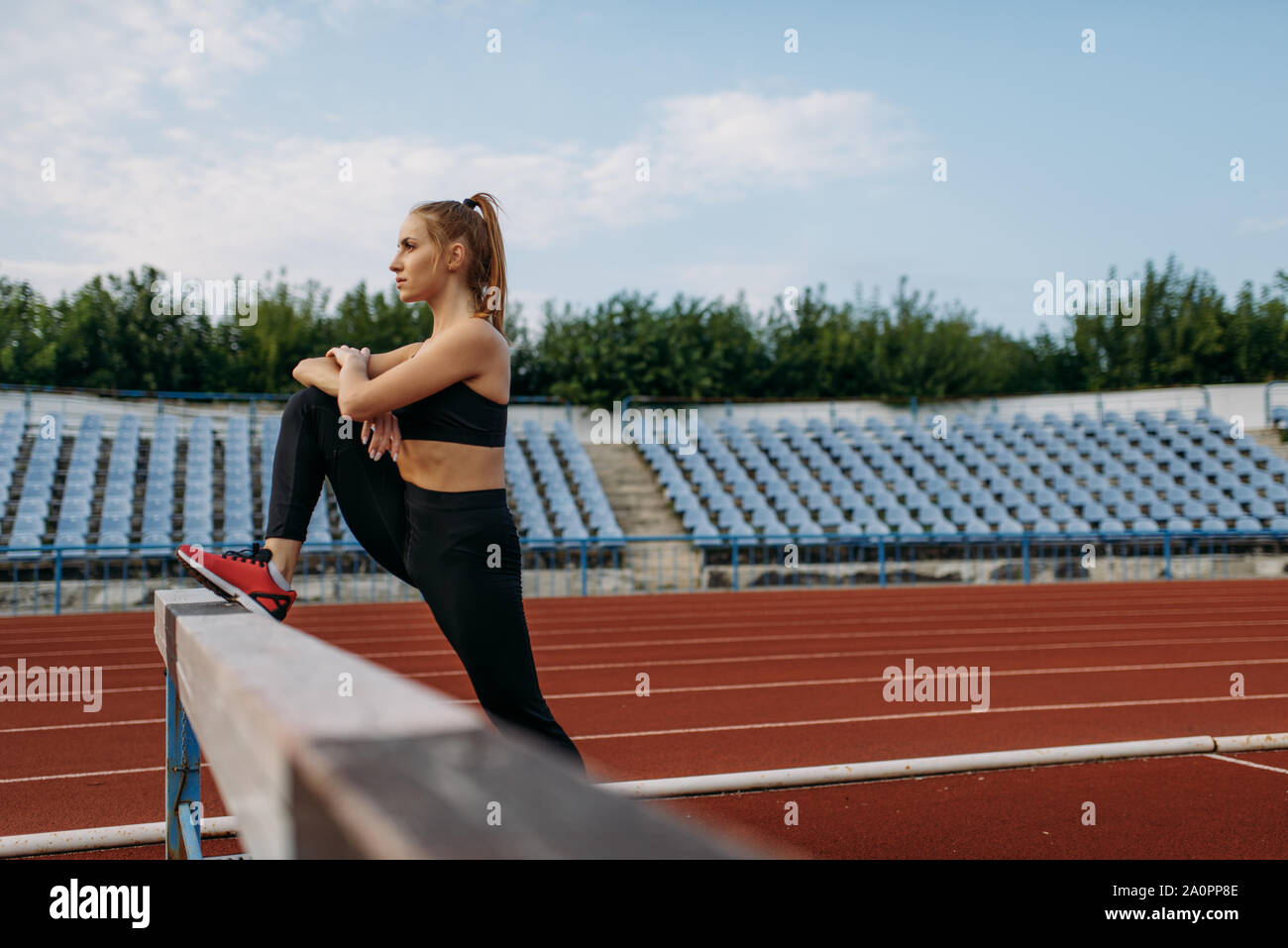 Female runner, stretching workout on stadium Stock Photo - Alamy