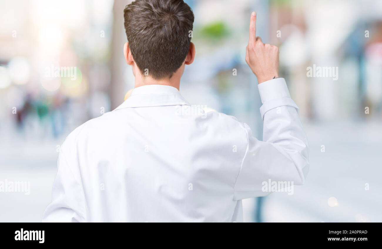 Young professional scientist man wearing white coat over isolated ...