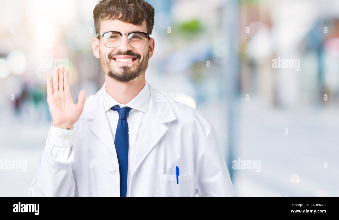 Young professional scientist man wearing white coat over isolated ...