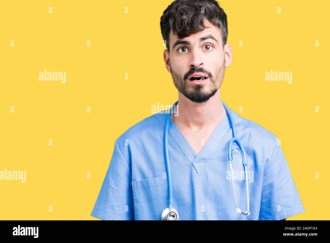 Young handsome nurse man wearing surgeon uniform over isolated ...