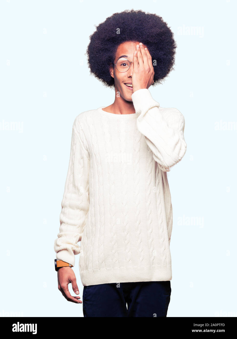 Young african american man with afro hair wearing glasses covering one ...