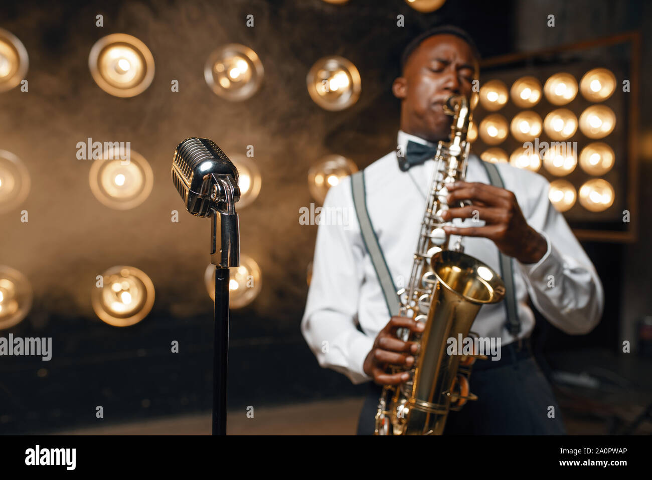 Male jazz performer plays the saxophone on stage Stock Photo - Alamy