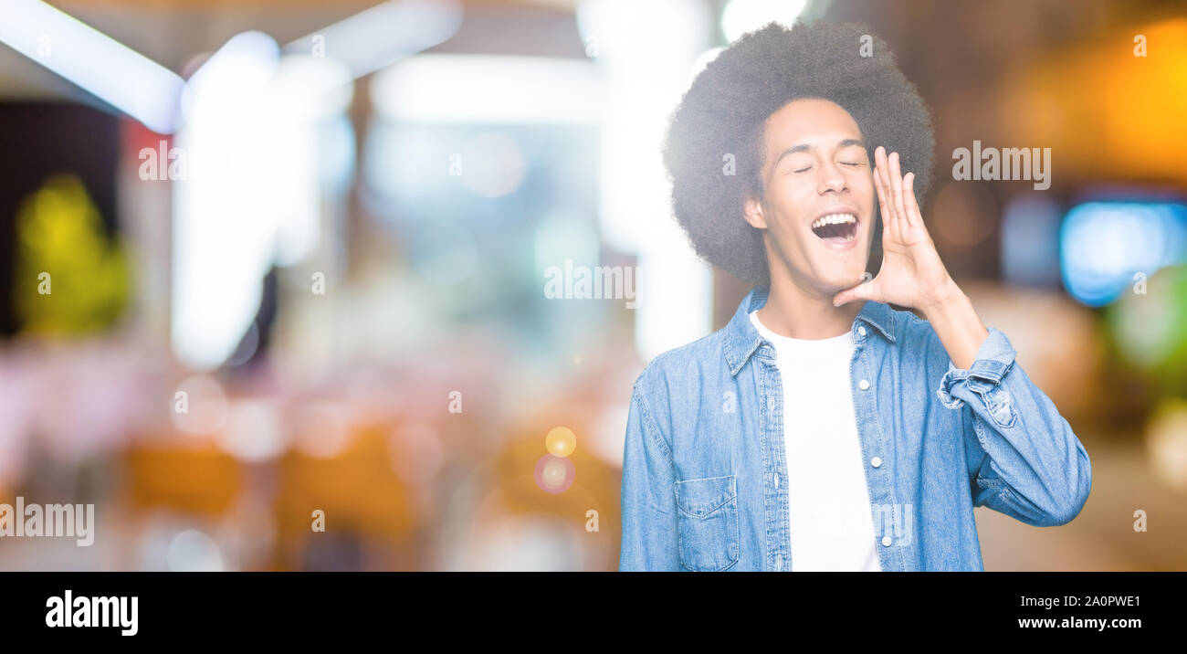 Young african american man with afro hair shouting and screaming loud ...