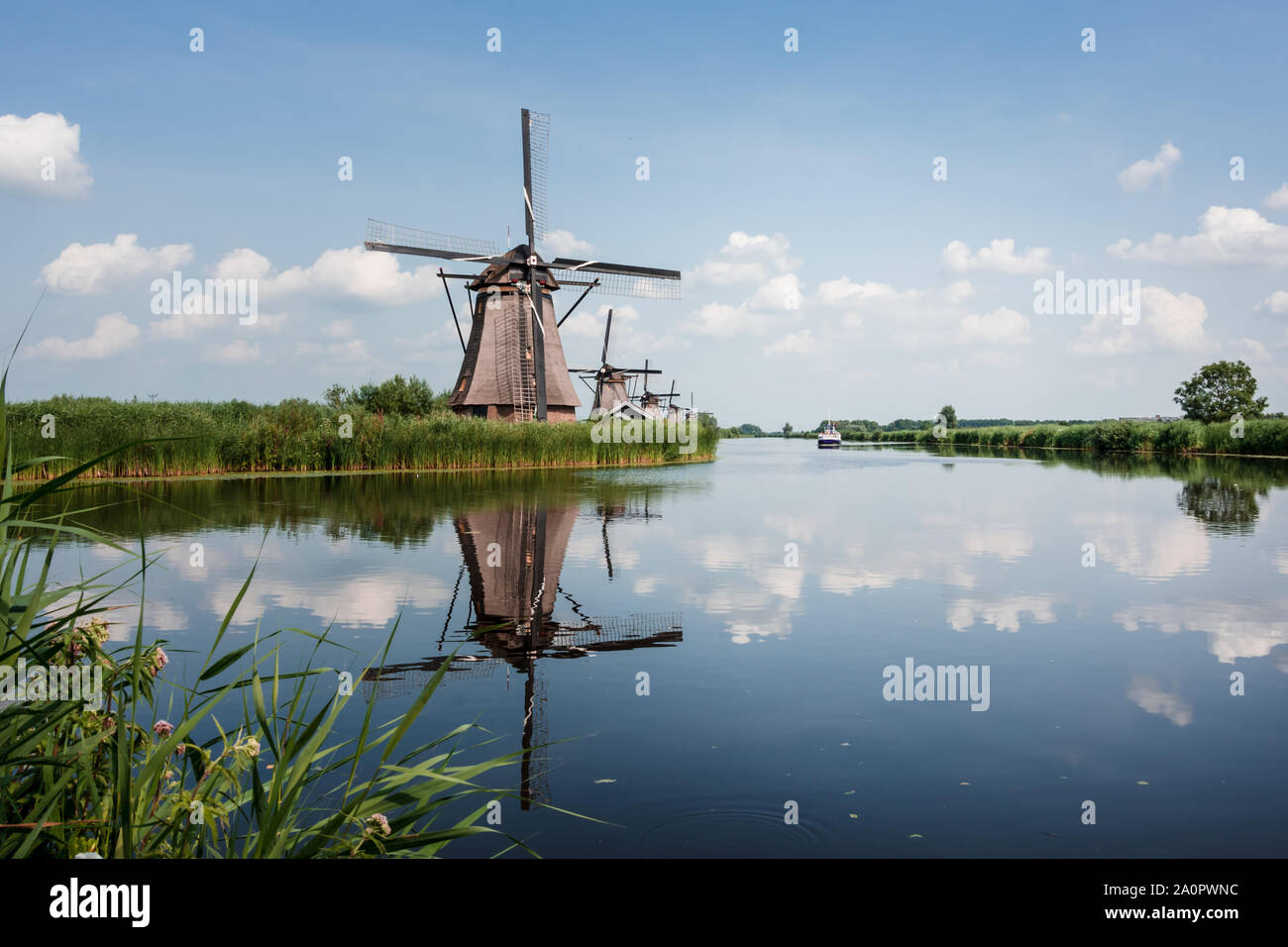 Old windmill on the edge of the lake Stock Photo - Alamy