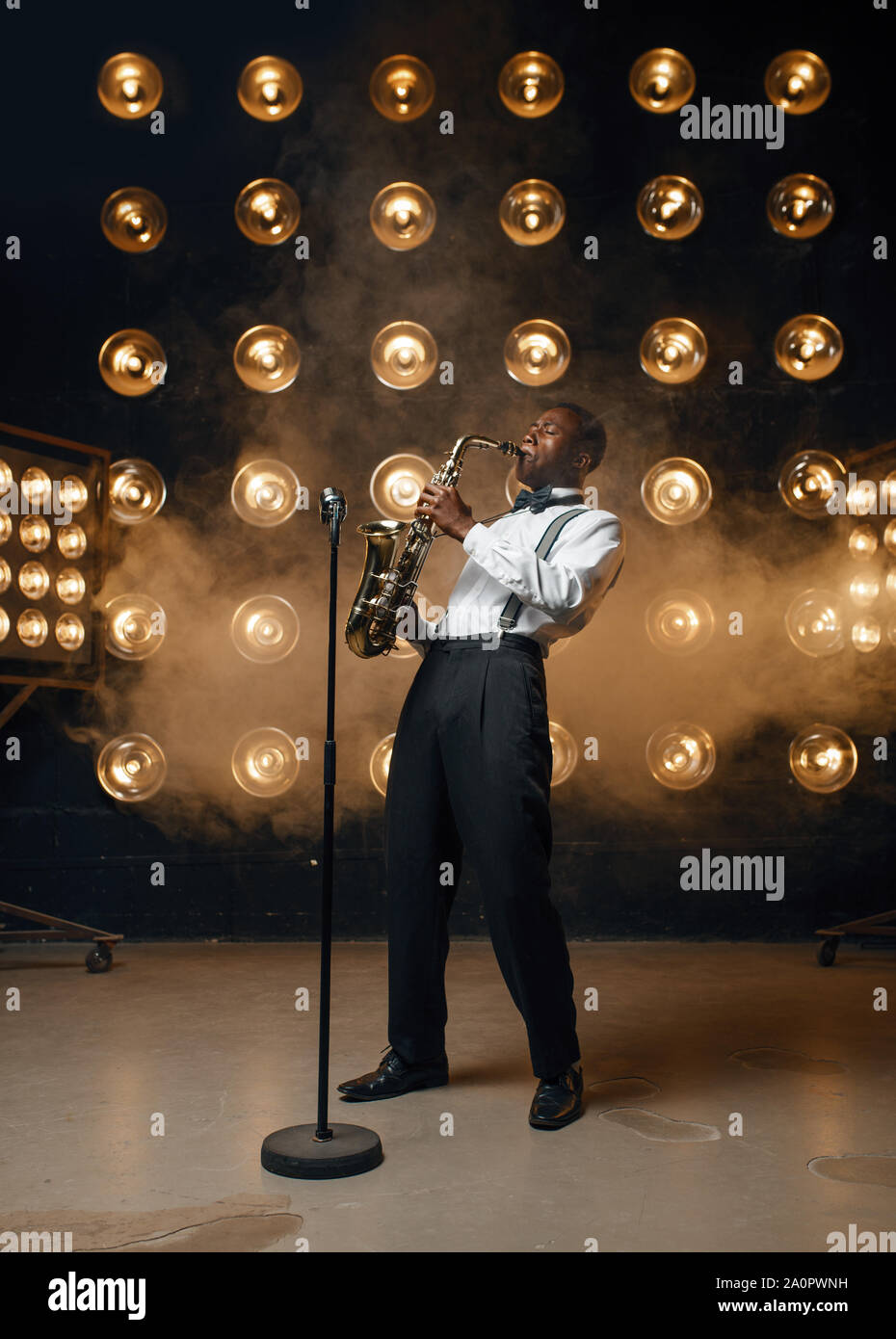 Male jazzman plays the saxophone on stage Stock Photo - Alamy