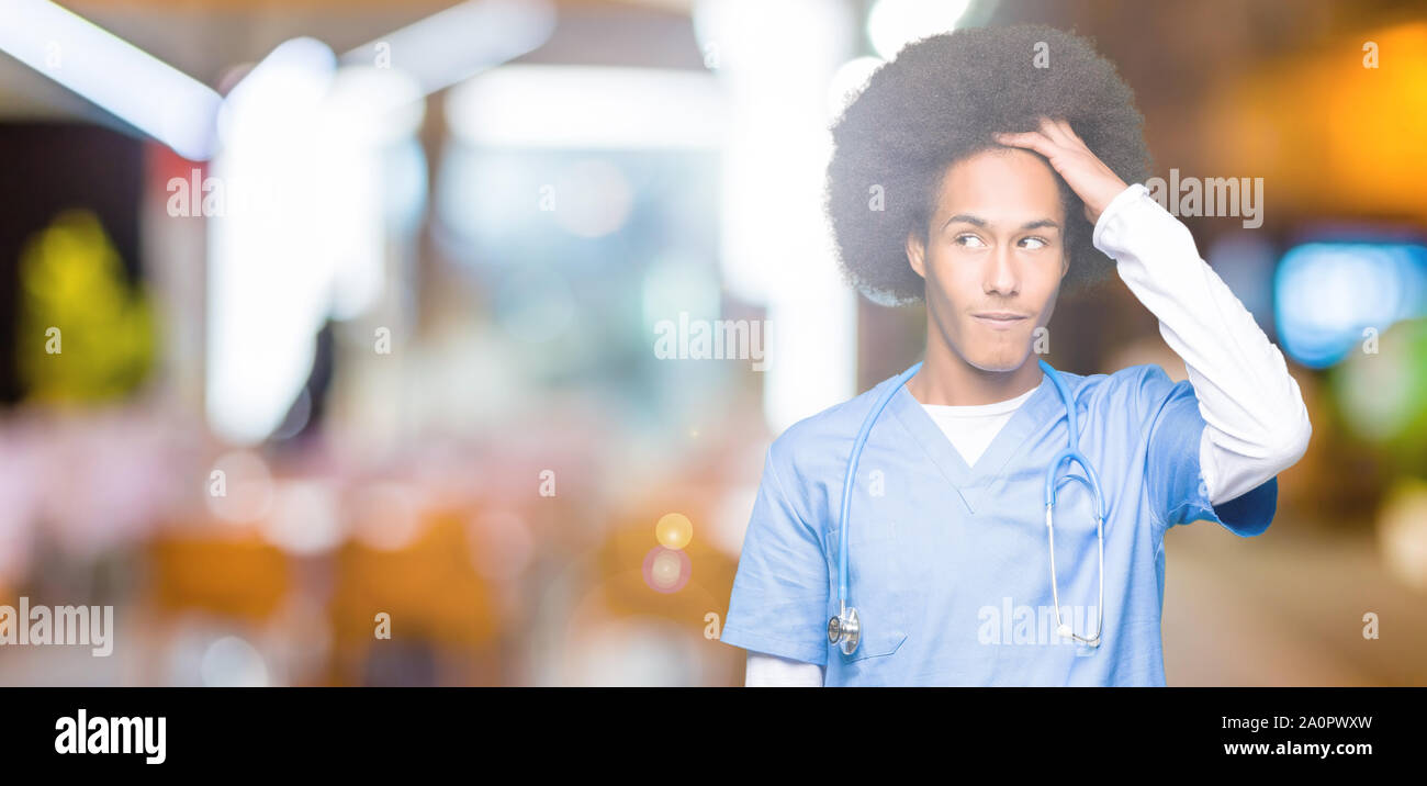 Young african american doctor man with afro hair confuse and wonder ...