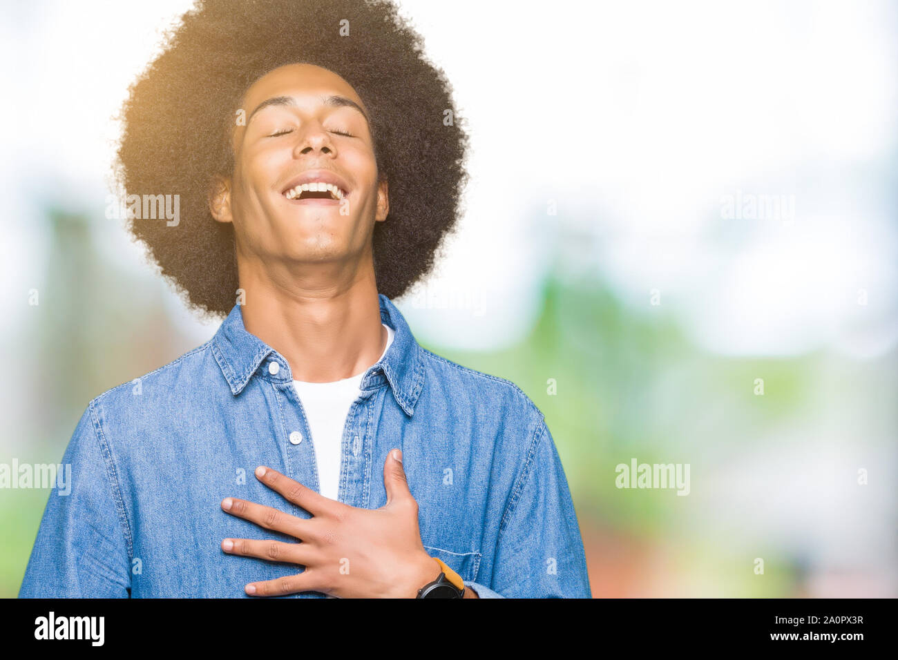 Young african american man with afro hair Smiling and laughing hard out ...