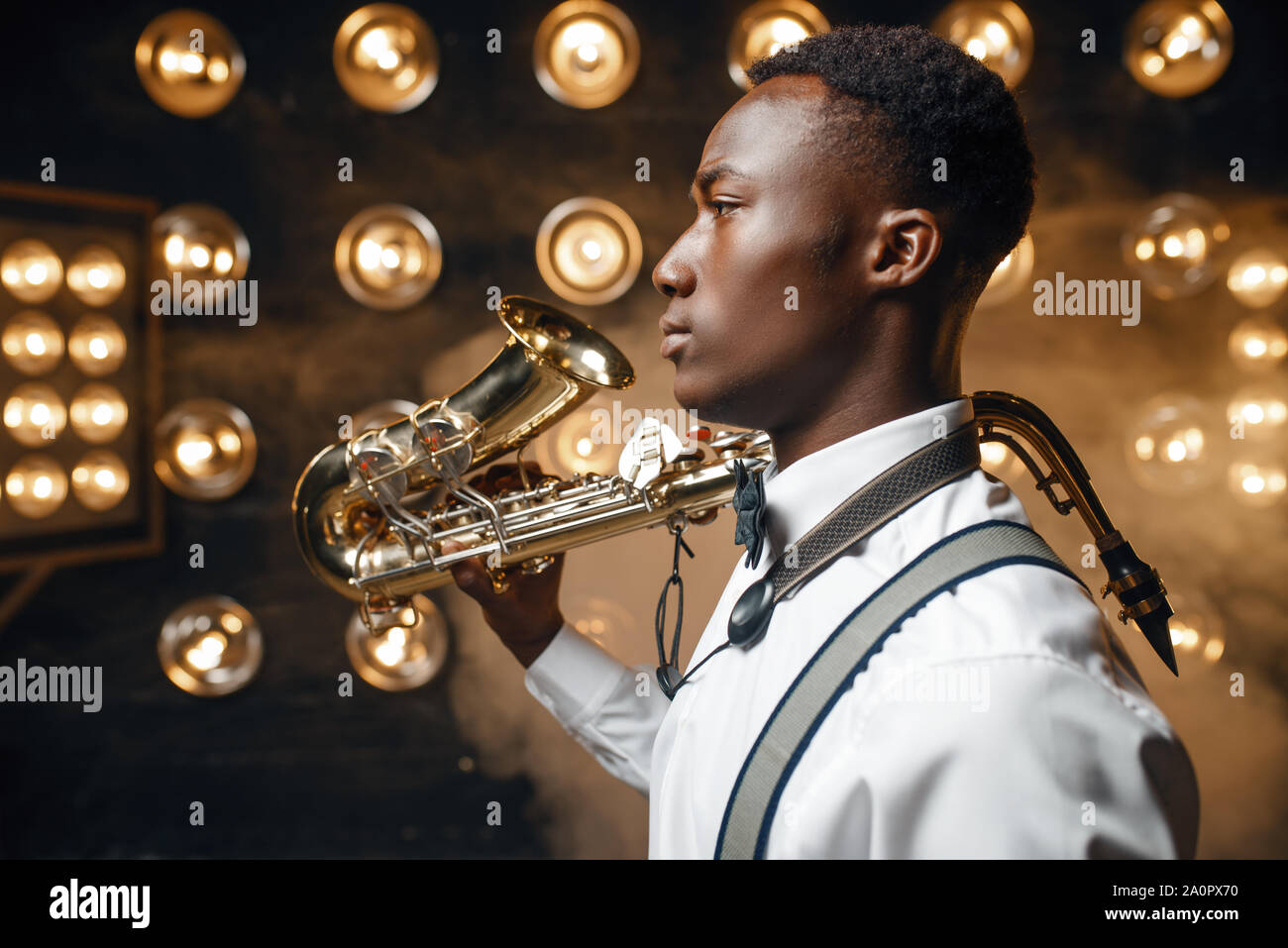 Black jazz performer poses with saxophone on stage Stock Photo - Alamy