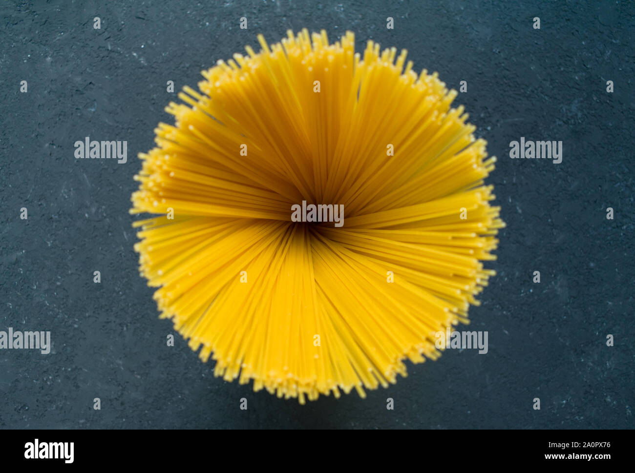 Yellow long spaghetti on a black background. Yellow Italian pasta. Raw ...