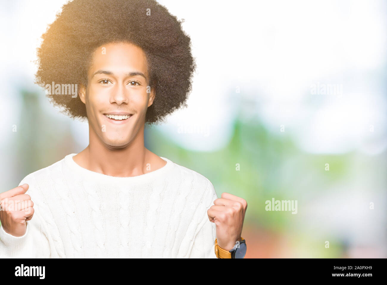 Young african american man with afro hair wearing winter sweater ...
