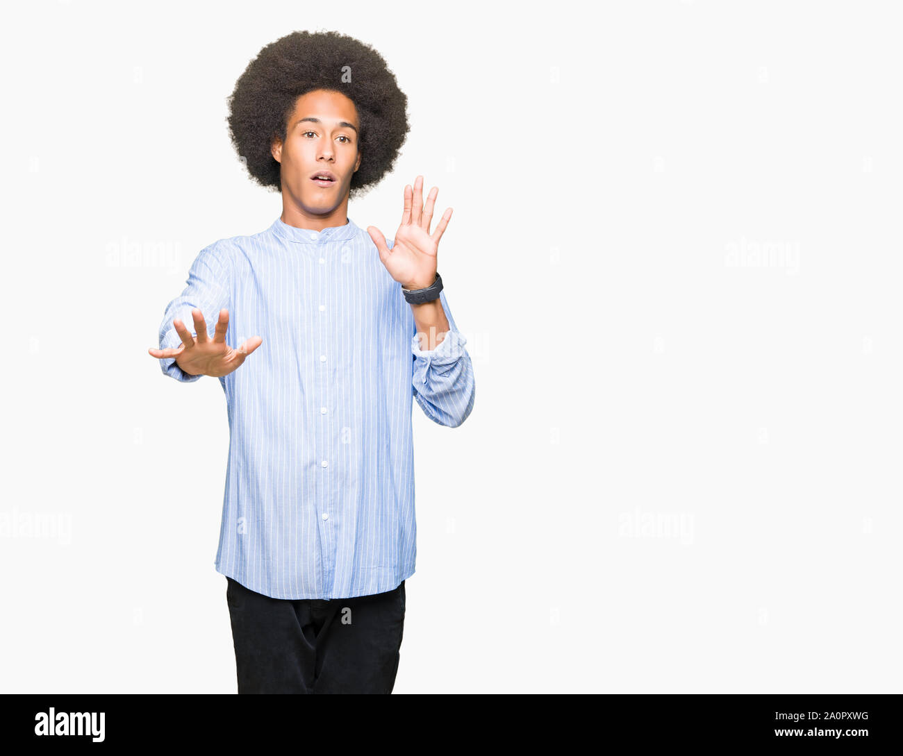 Young african american man with afro hair afraid and terrified with ...