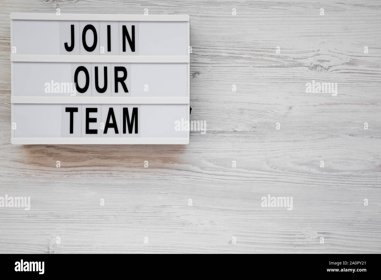 'Join our team' words on a modern board on a white wooden surface, top ...