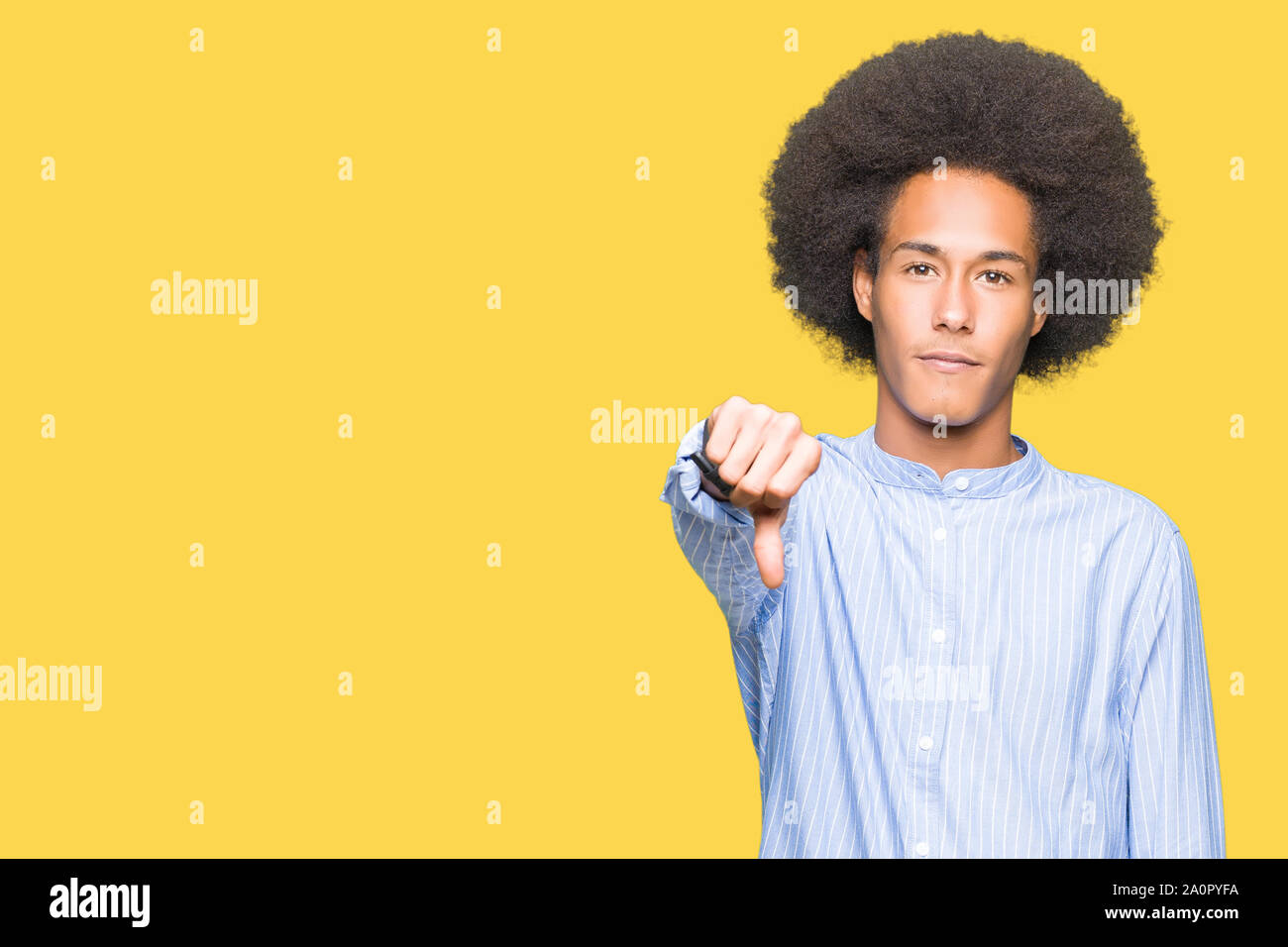 Young african american man with afro hair looking unhappy and angry ...