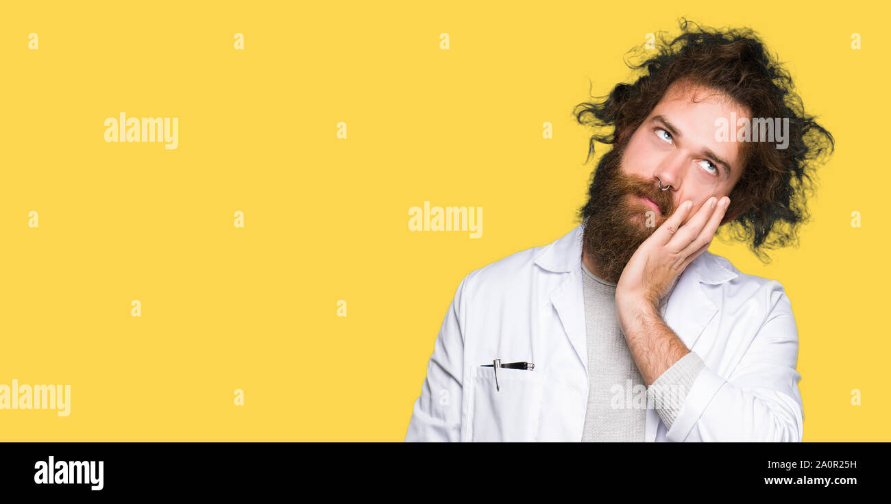 Crazy scientist with funny long hair thinking looking tired and bored ...