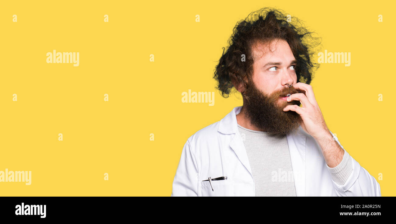 Crazy scientist with funny long hair looking stressed and nervous with ...