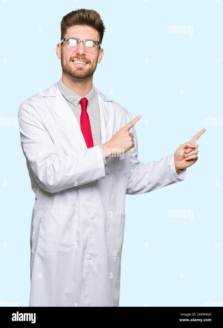 Young handsome scientist man wearing glasses smiling and looking at the ...